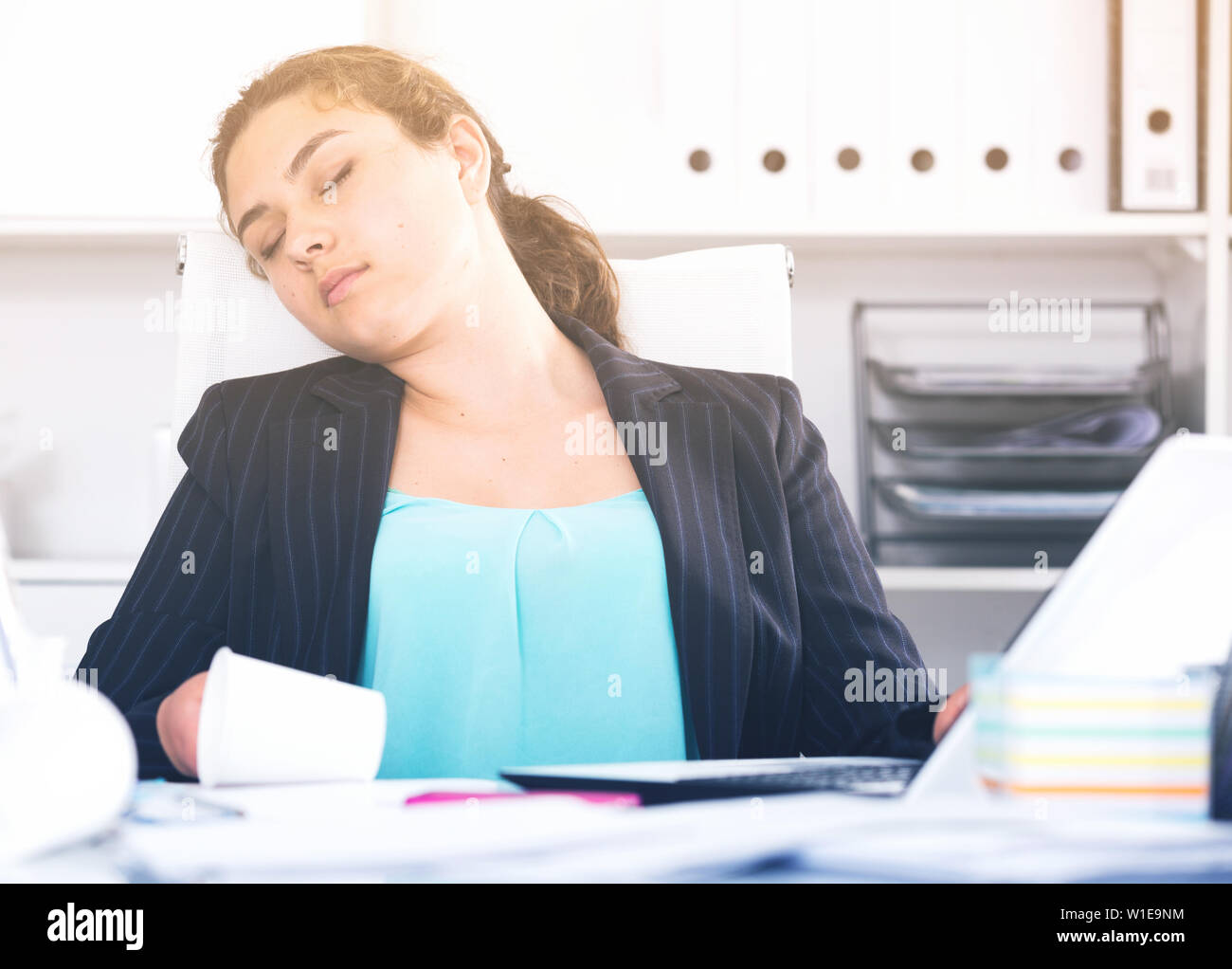 Female manager is sleeping at work after putting the reports in the ...