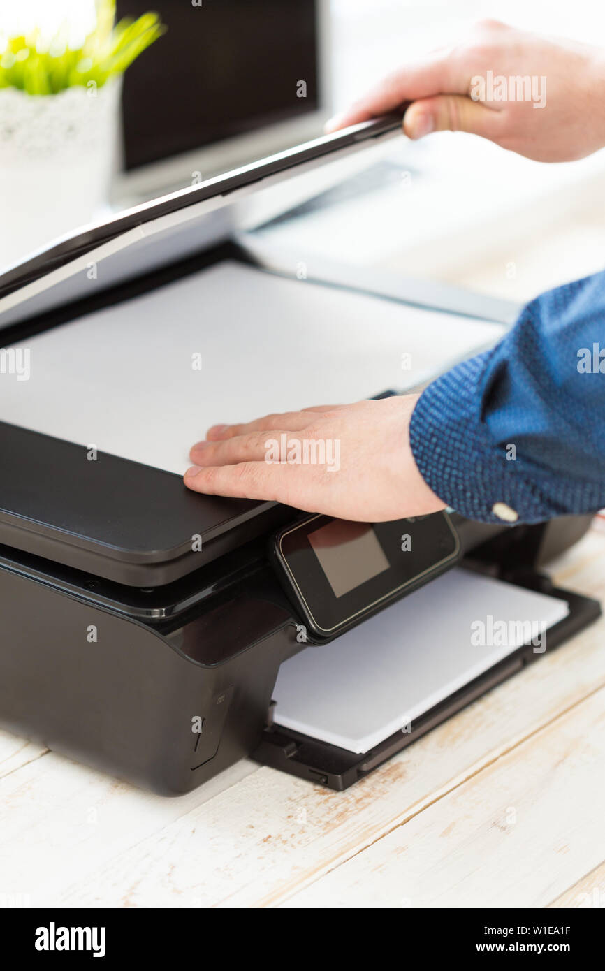Man's hand making copies. Working with printer Stock Photo - Alamy