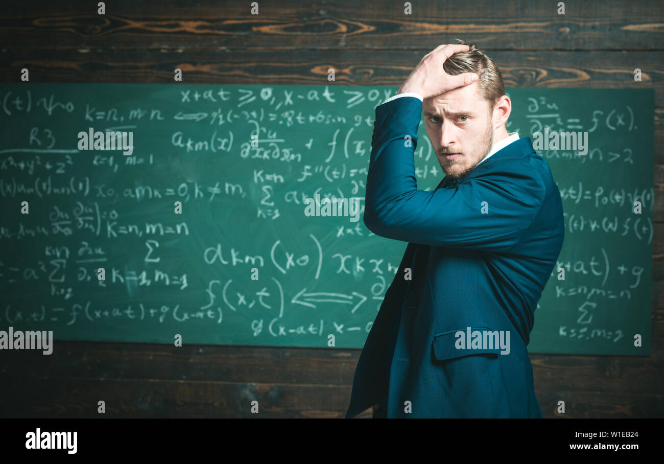 Unproven theorem. Man formal wear classic suit looks smart, chalkboard ...