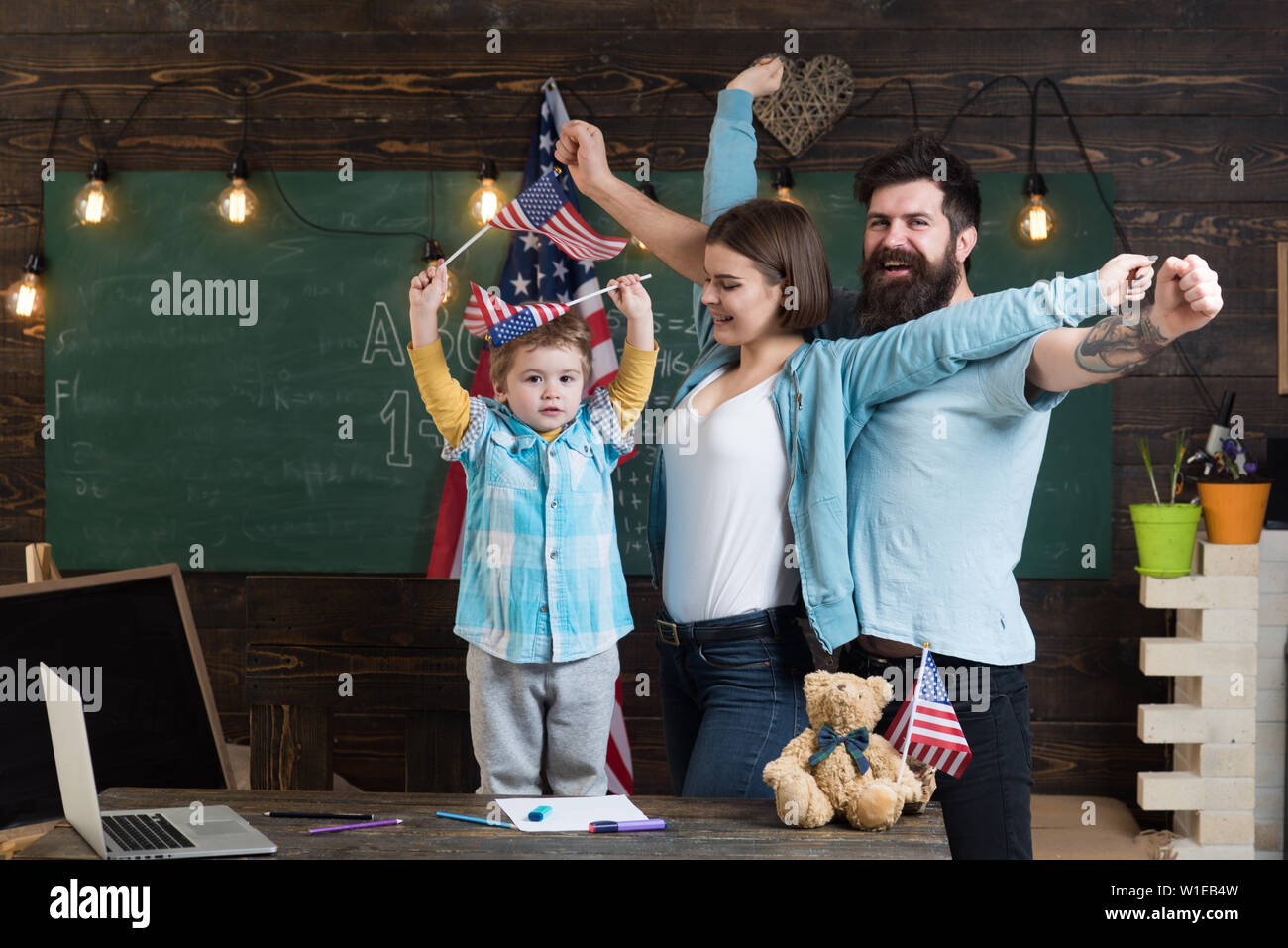 American cheerful family with son and usa flags. Kid with parents in ...