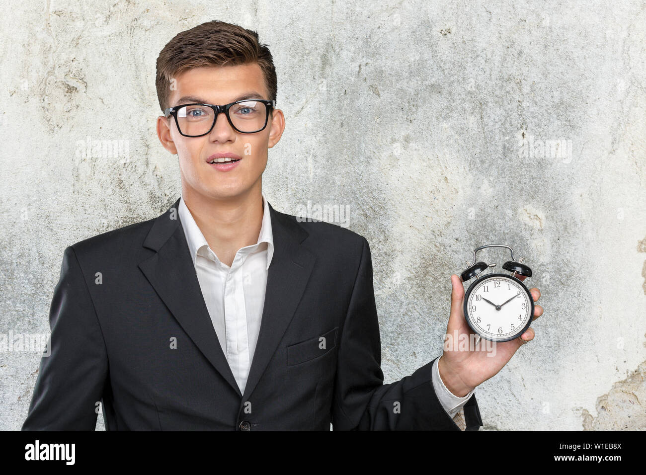 Successful businessman in formal wear pointing at clock Stock Photo - Alamy