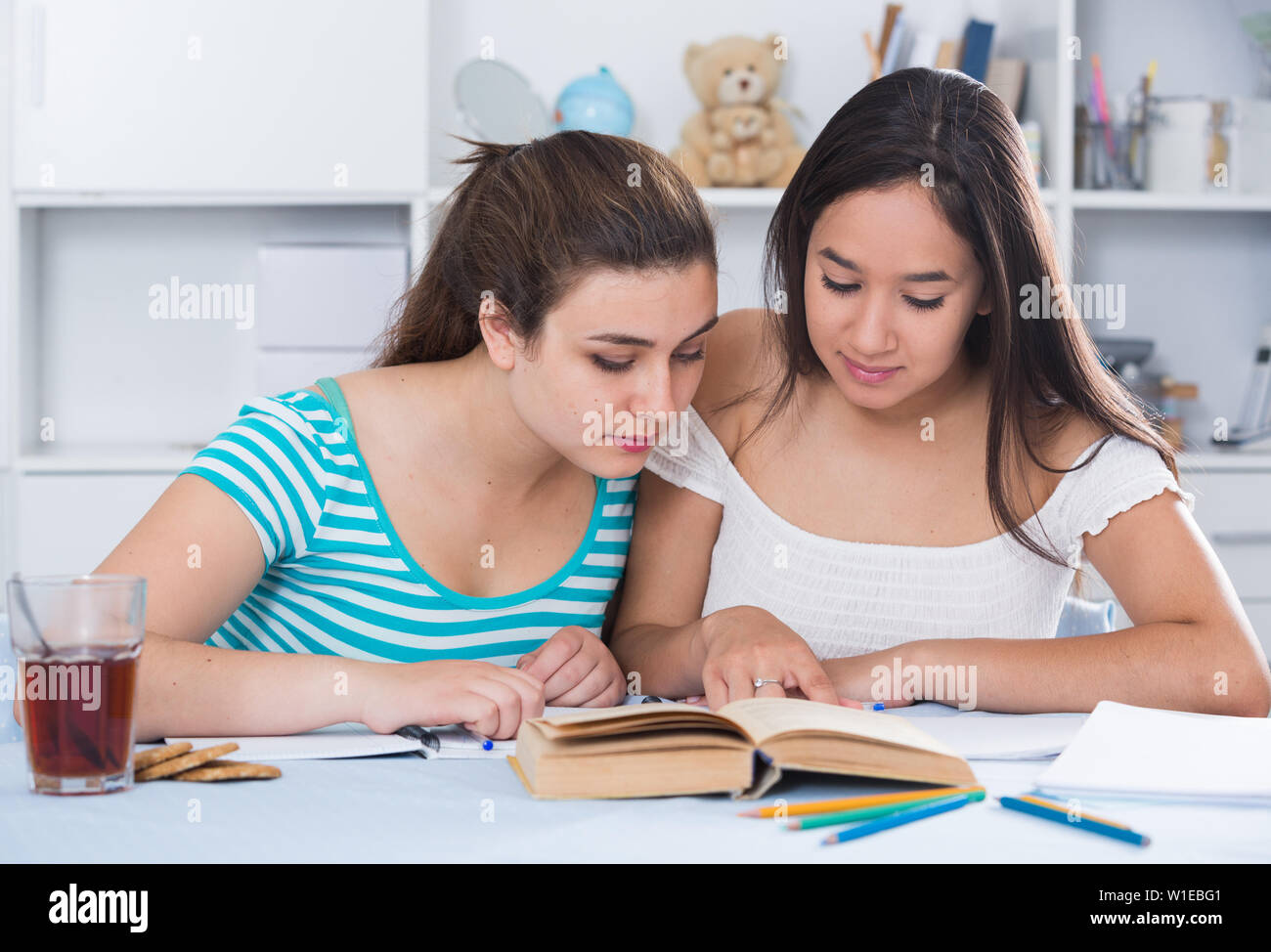 Teenage girls studying together at home hi-res stock photography and ...