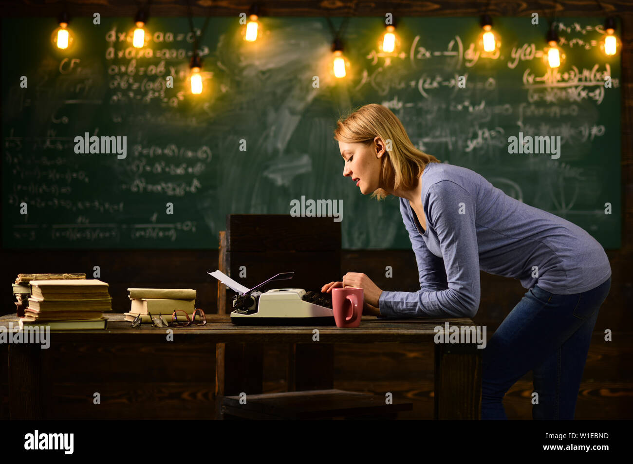 woman typing on a typewriter in school Stock Photo - Alamy