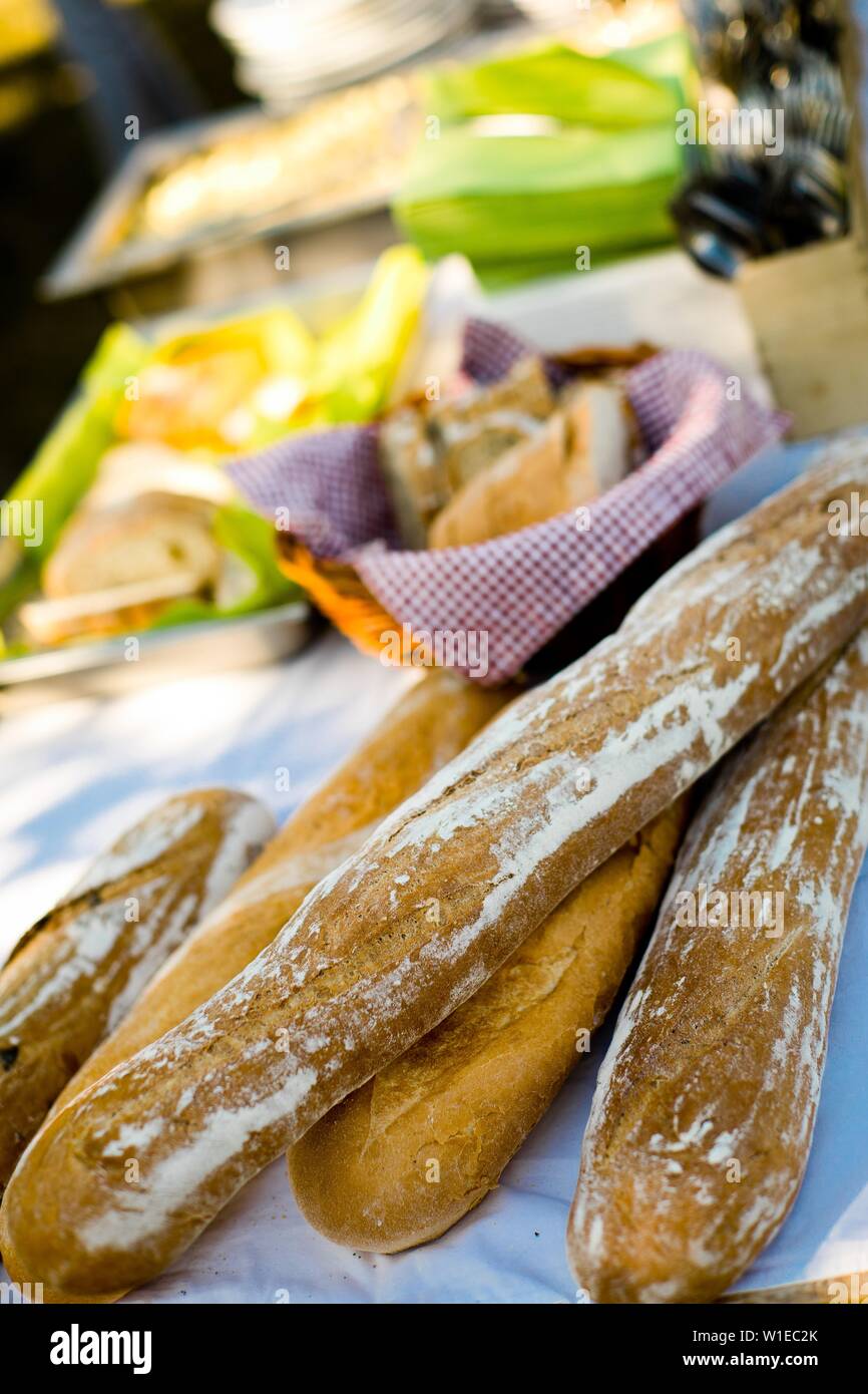 Long breads on table, outdoor picnic food preparation Stock Photo - Alamy