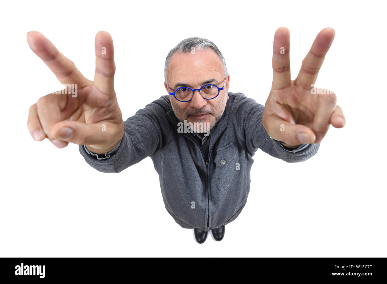 man making the victory sign on a white background Stock Photo - Alamy