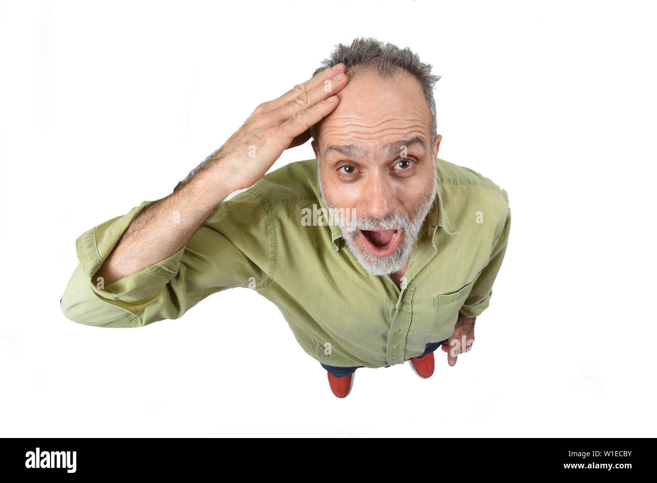 man with expression of forgetfulness or surprise on white background ...