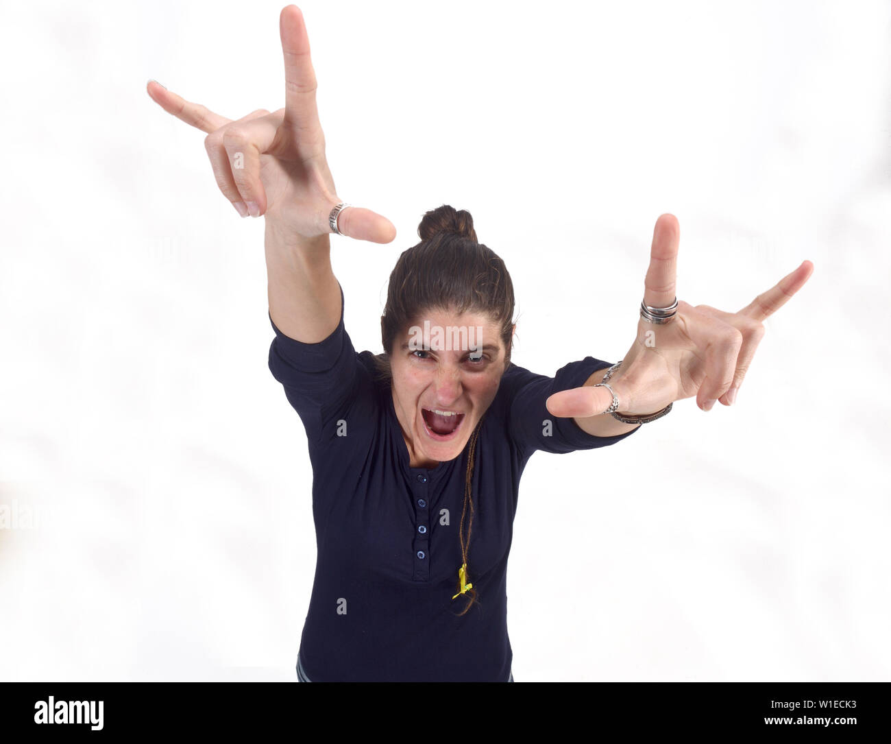 Woman making the horns on white background Stock Photo - Alamy