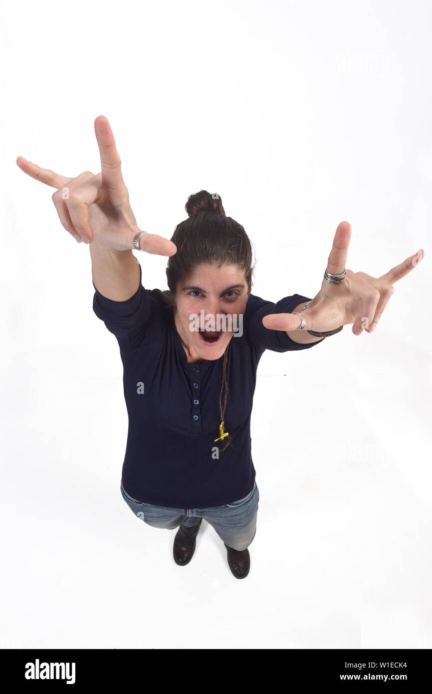 Woman making the horns on white background Stock Photo - Alamy