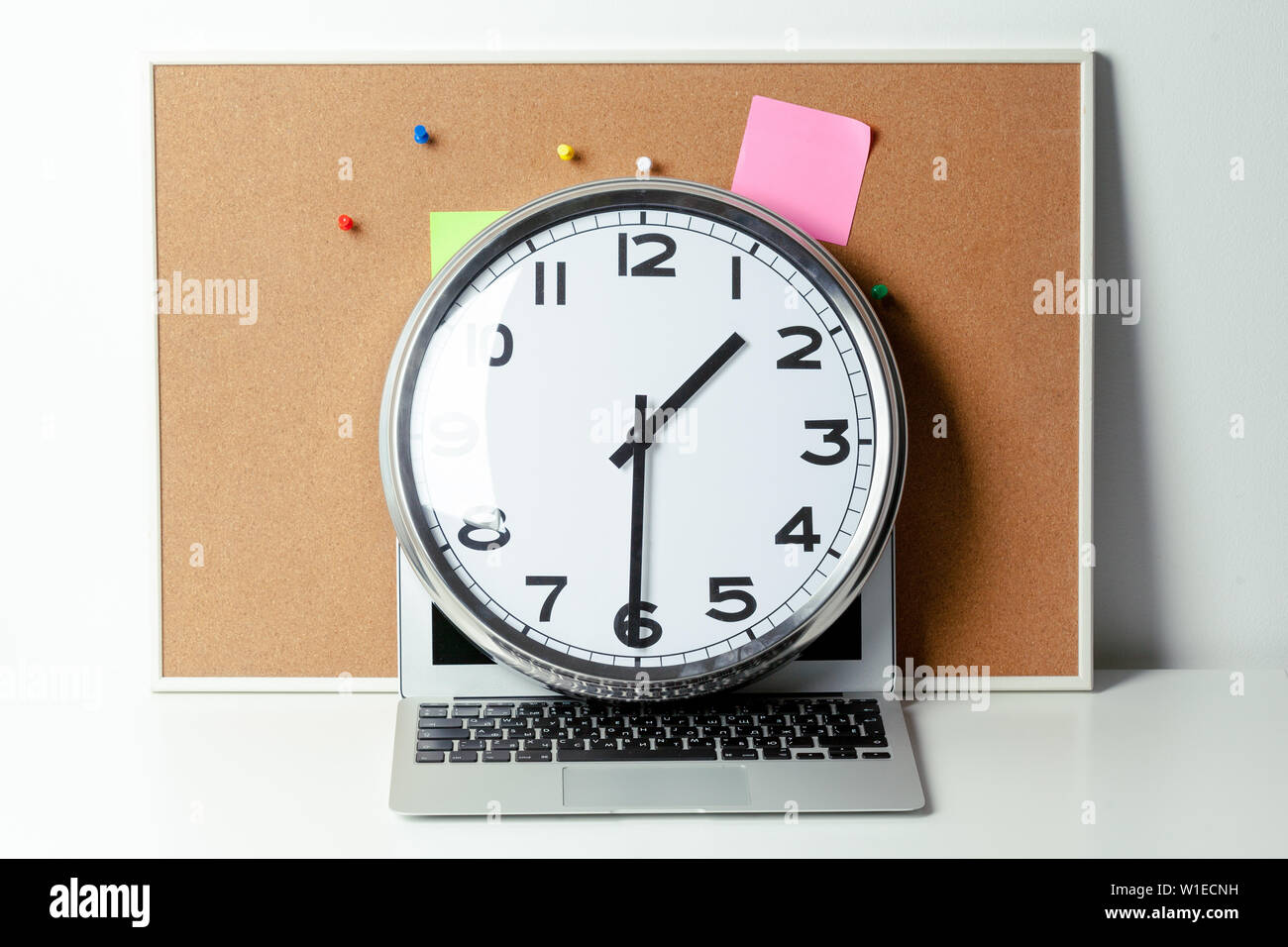 Clock at an office table Stock Photo - Alamy
