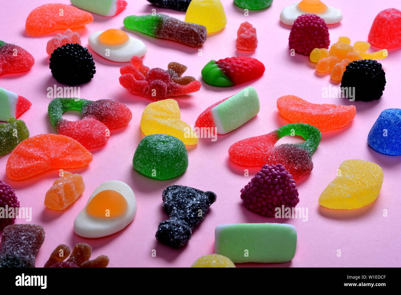 group of gummy candies on pink background Stock Photo - Alamy