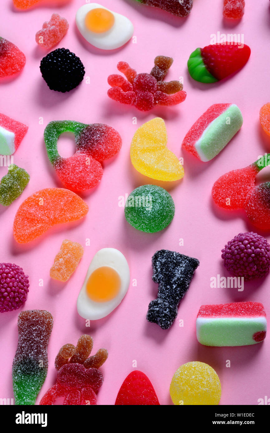 group of gummy candies on pink background Stock Photo - Alamy