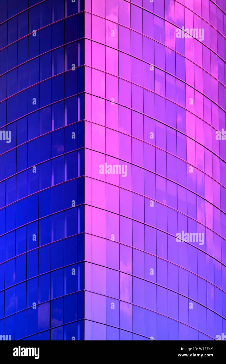 Neon colored Office Building reflections in the glass skyscraper wall ...