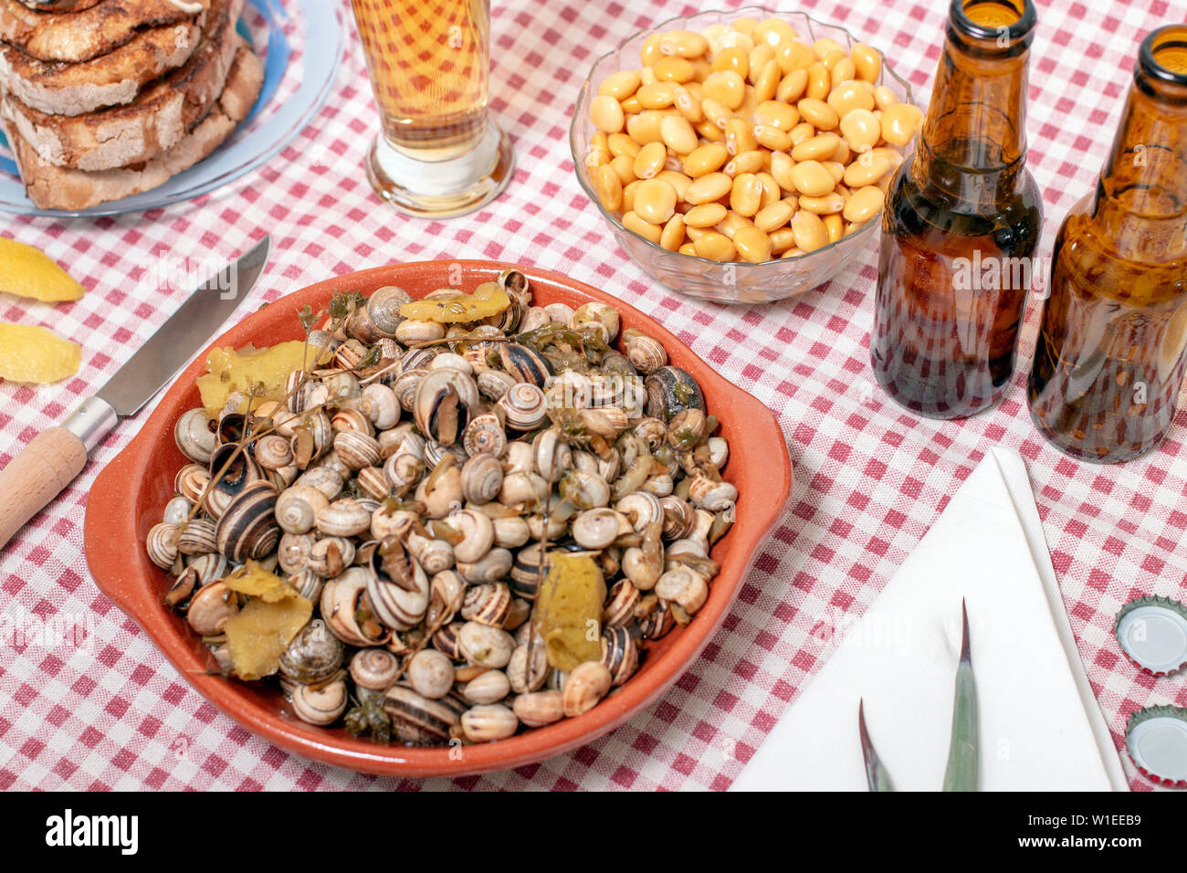 Traditional Portuguese dish of cooked snails and toasted bread and beer ...