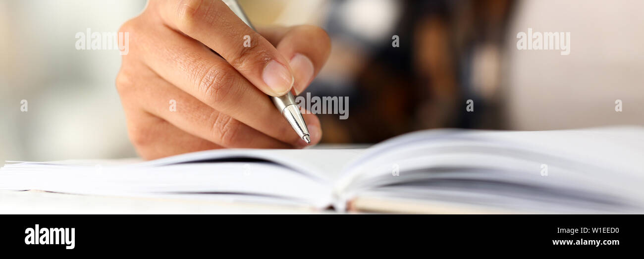 Arm of black woman write story in notebook Stock Photo - Alamy