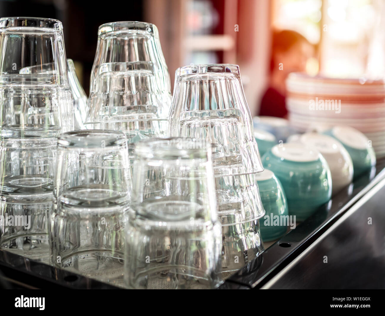 Pile of empty clean transparent glasses on shelf in cafe Stock Photo ...