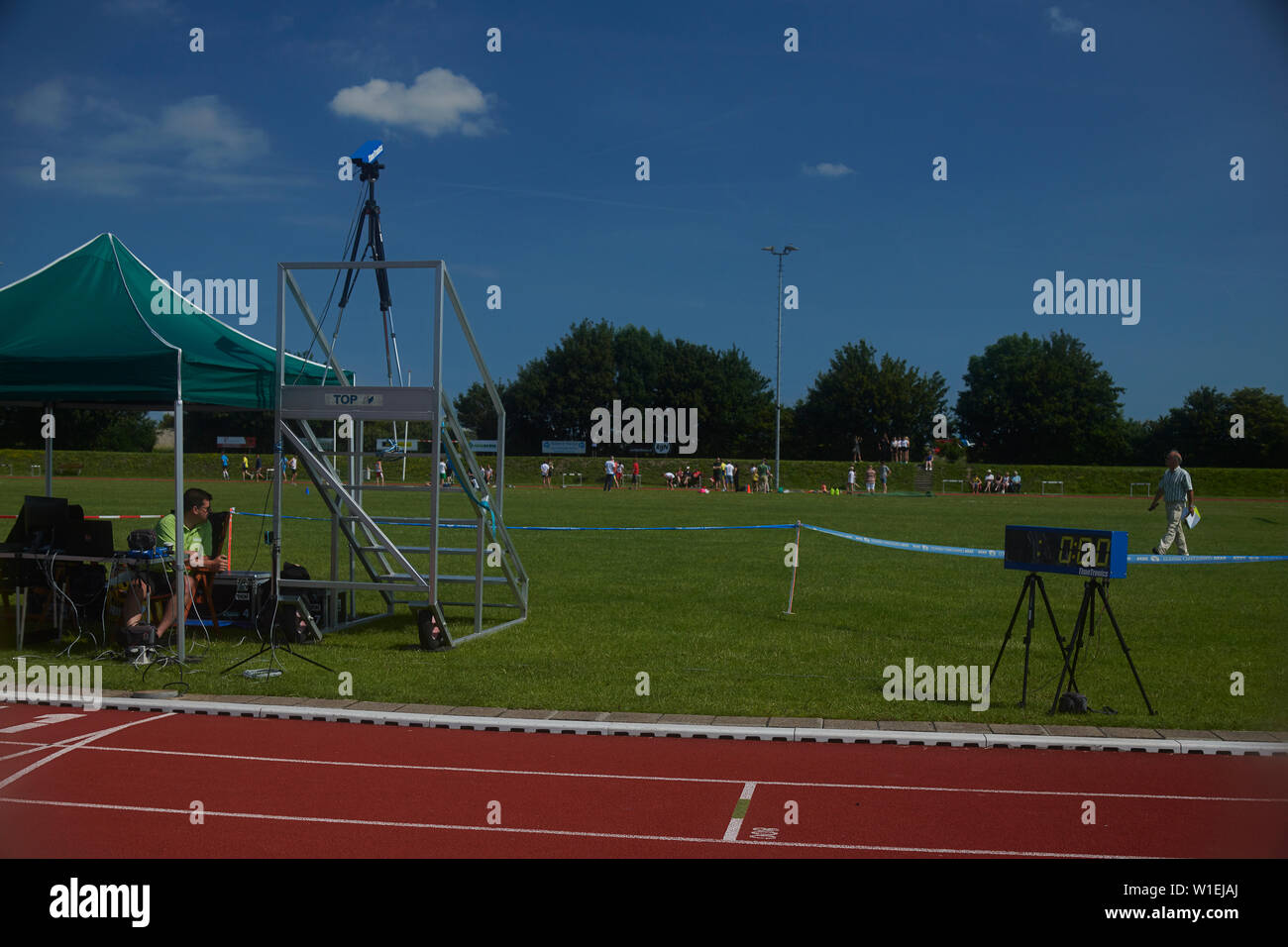 Black boy running across the finish line in first position at an ...