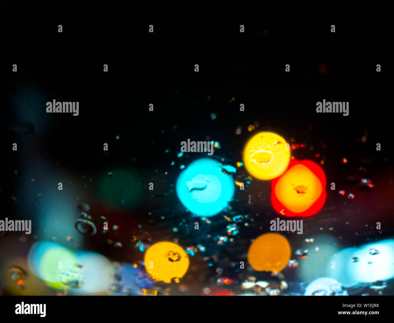Blurred rain drops texture on car window with colorful bokeh abstract ...
