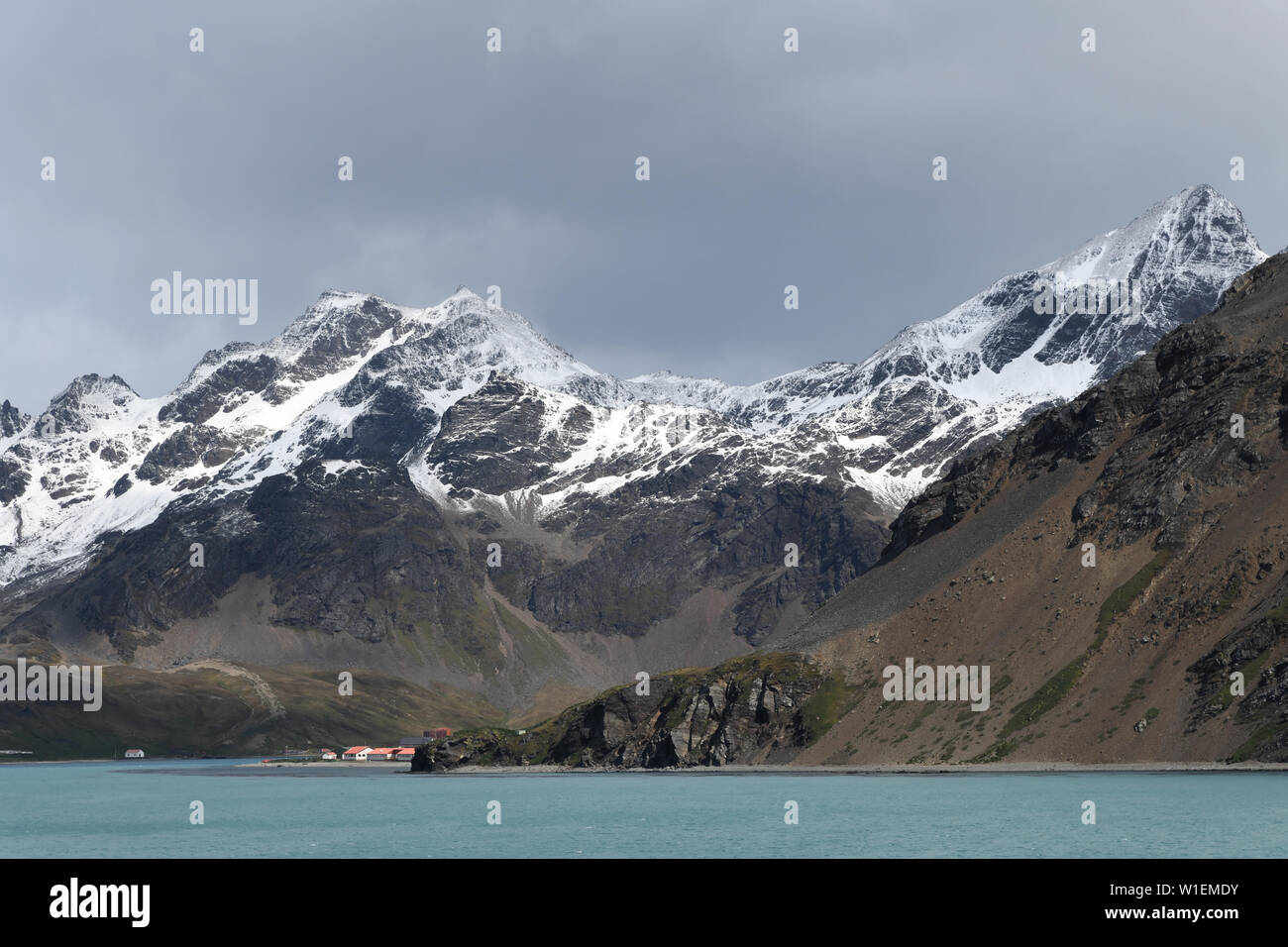 King Edward Point research station at the foot of the snow covered ...