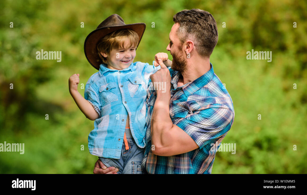 Small helper in garden. Little boy and father in nature background ...