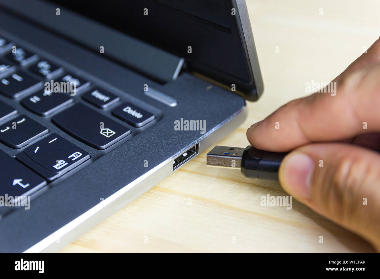 hand man hold Flash drive connect to USB port plug-in computer laptop ...