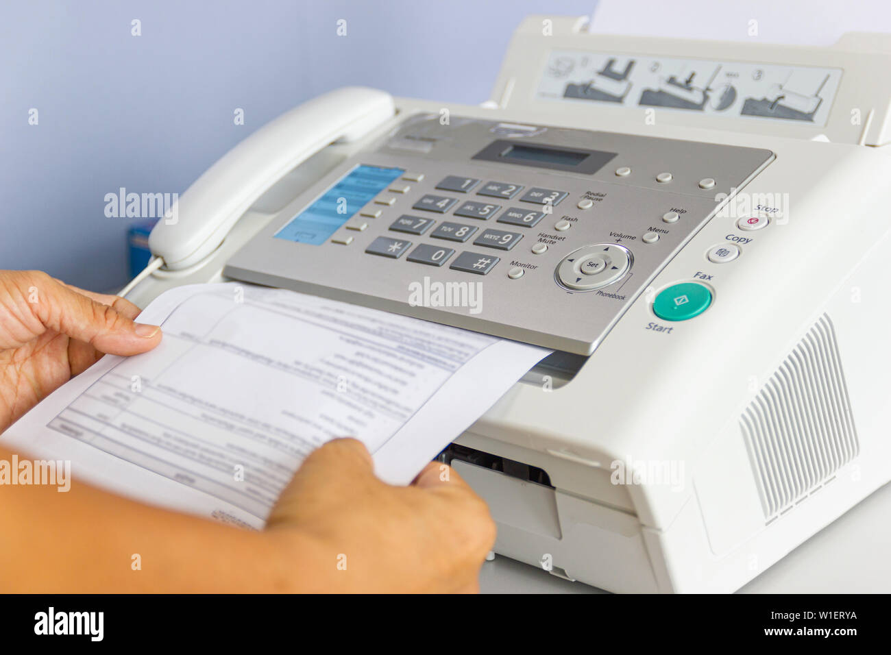 hand man are using a fax machine in the office Business concept Stock ...