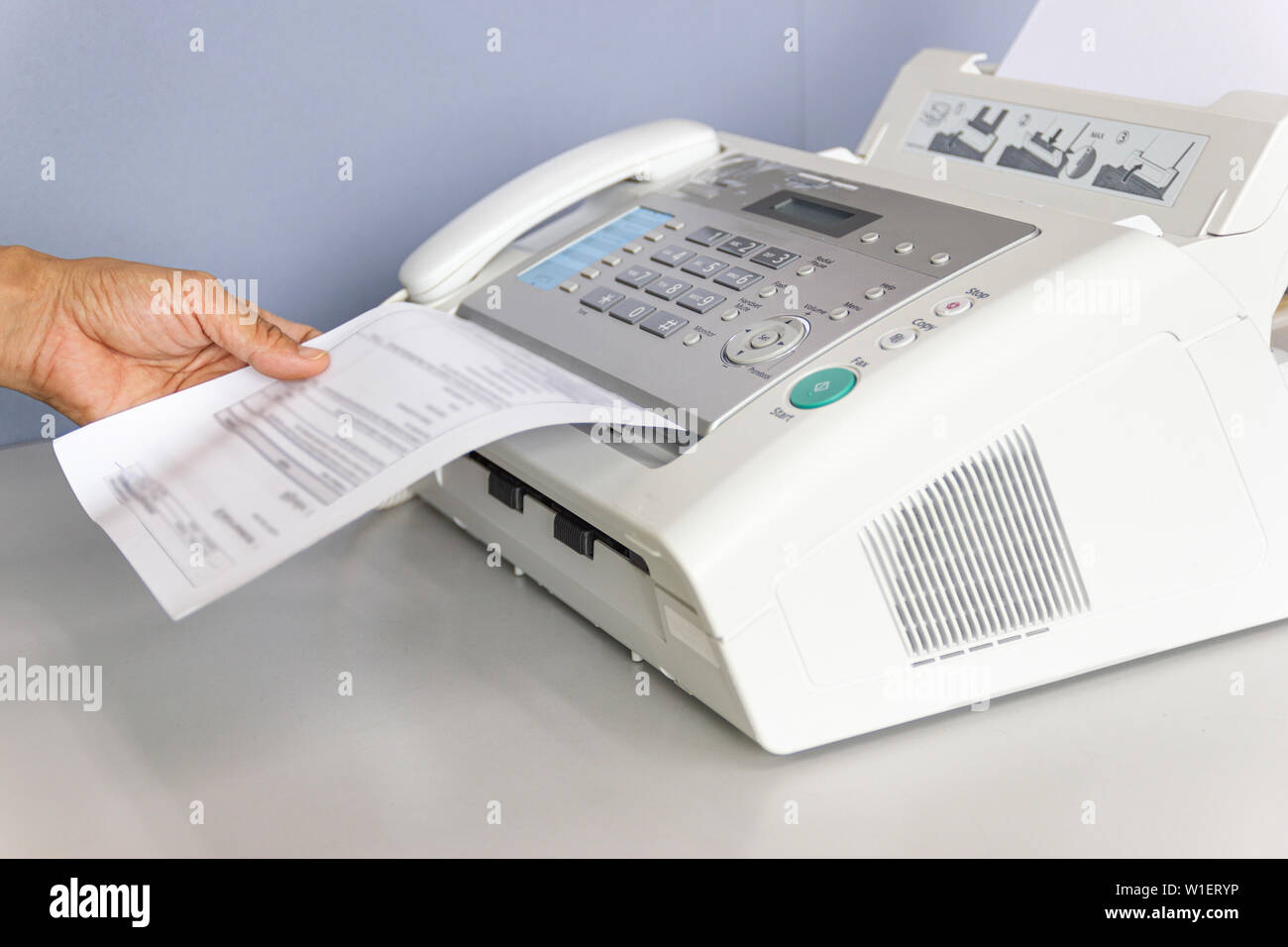 hand man are using a fax machine in the office Business concept Stock ...