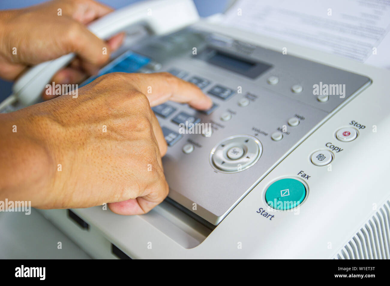 hand man are using a fax machine in the office Business concept Stock ...