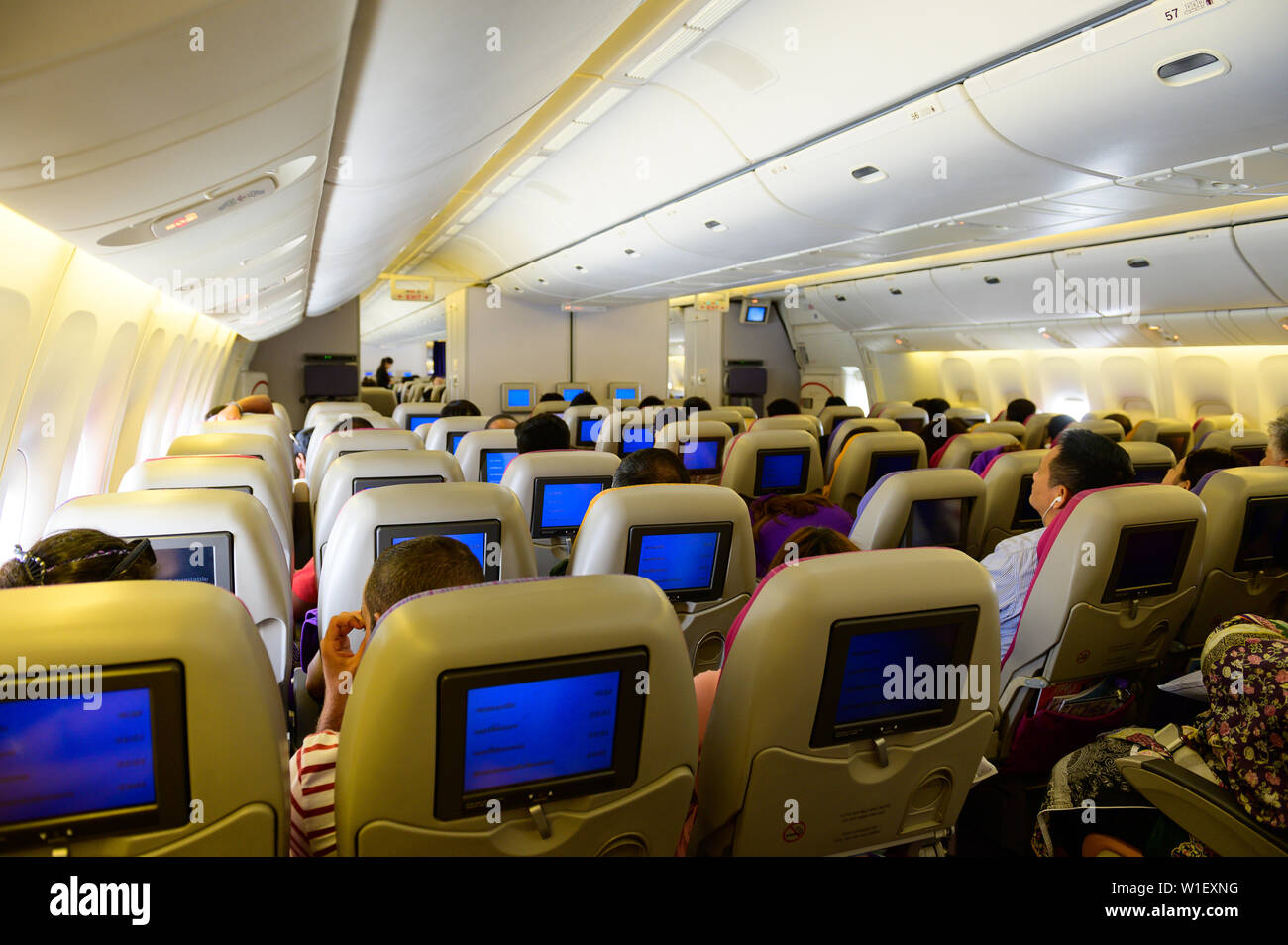 Seats inside the airplane and passenger sitting all area Stock Photo ...