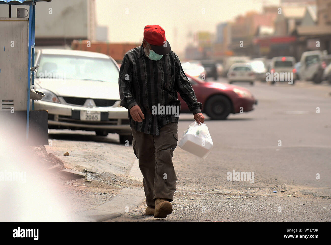 Kuwait City, Kuwait. 2nd July, 2019. A local resident walks in heavy ...