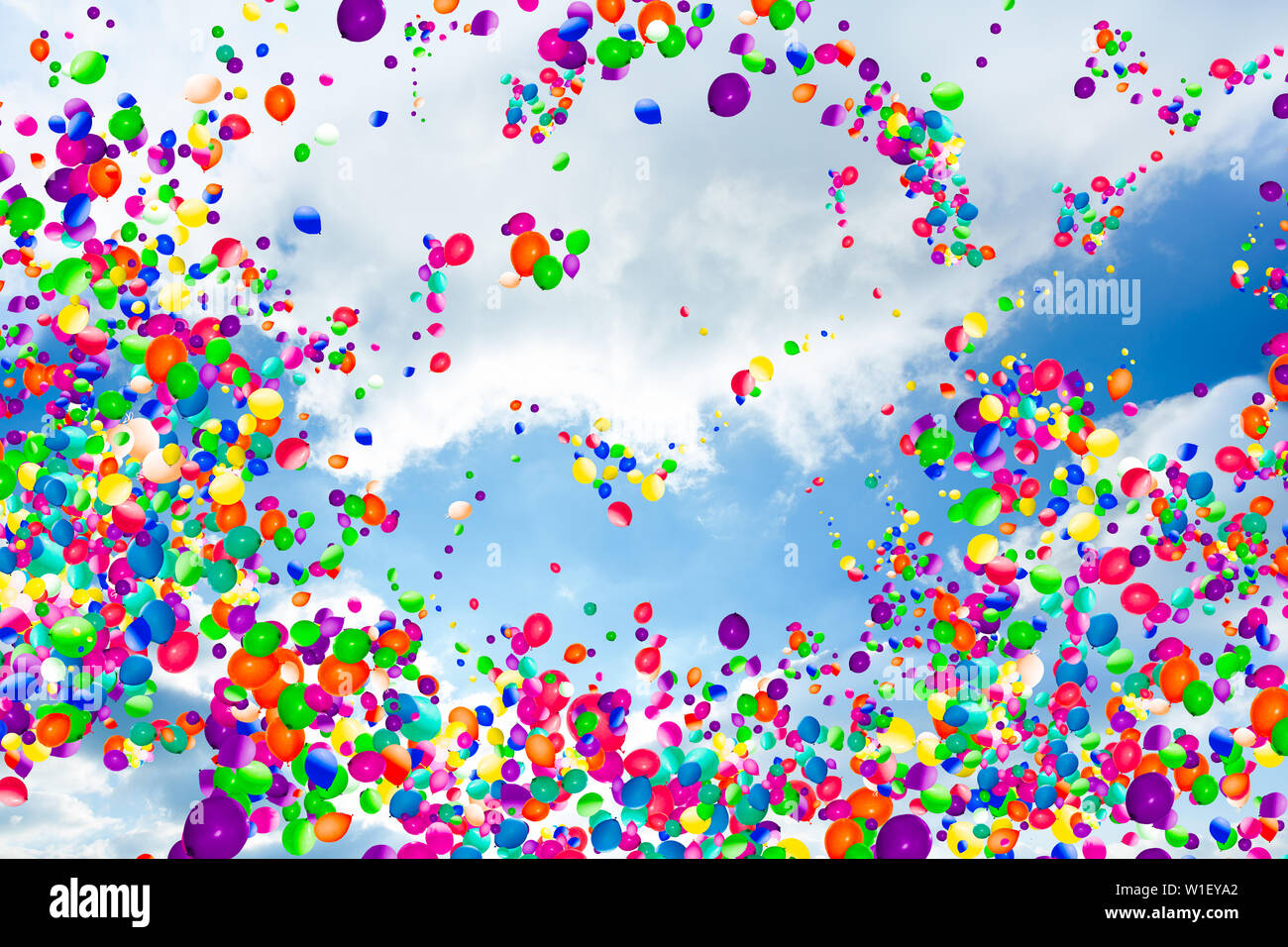 Very large group of hot air festive balloons fly in the blue sky and ...