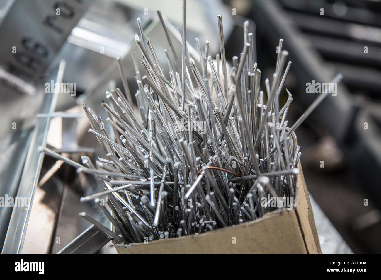 Cardboard container full of metal pieces Stock Photo - Alamy
