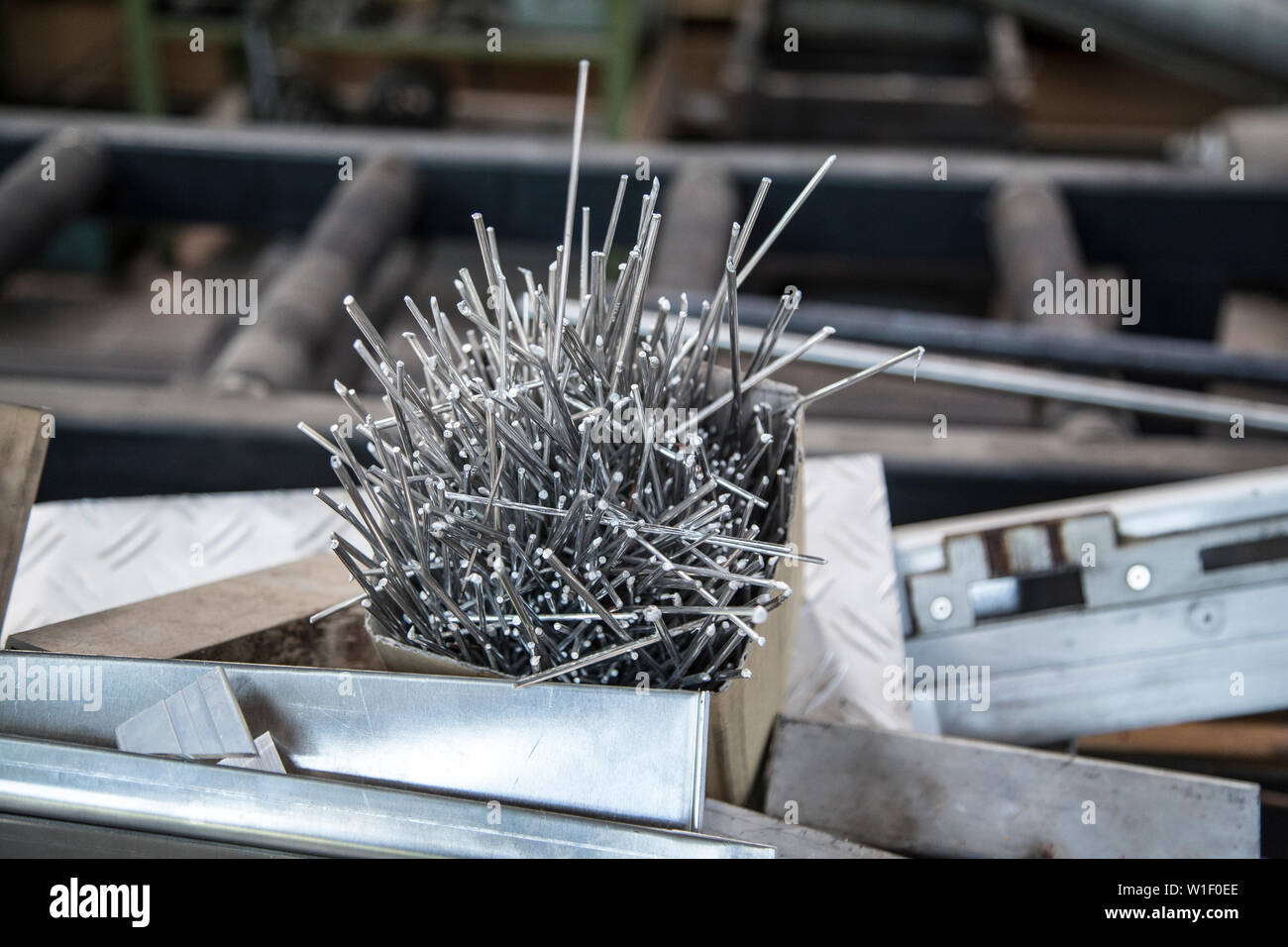 Cardboard container full of metal pieces Stock Photo - Alamy