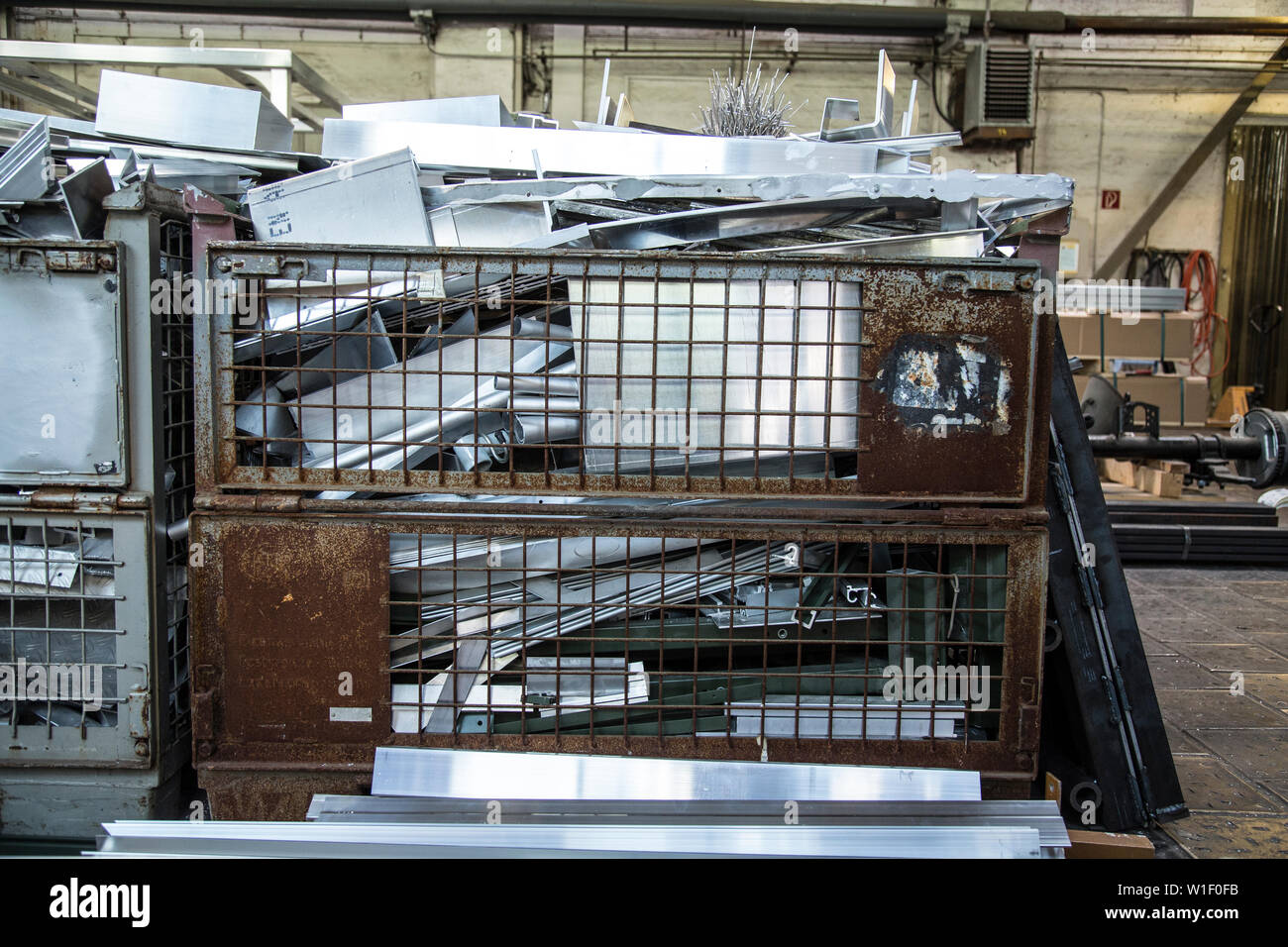 Container with metal objects at workshop Stock Photo - Alamy