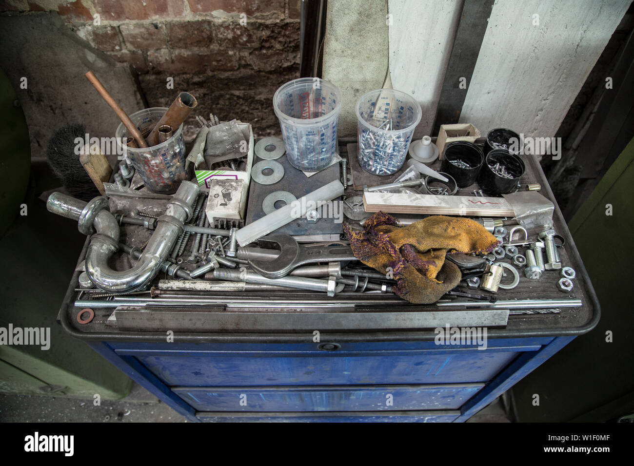 Workshop entrance or shopfront with various parts and tools lying hi ...