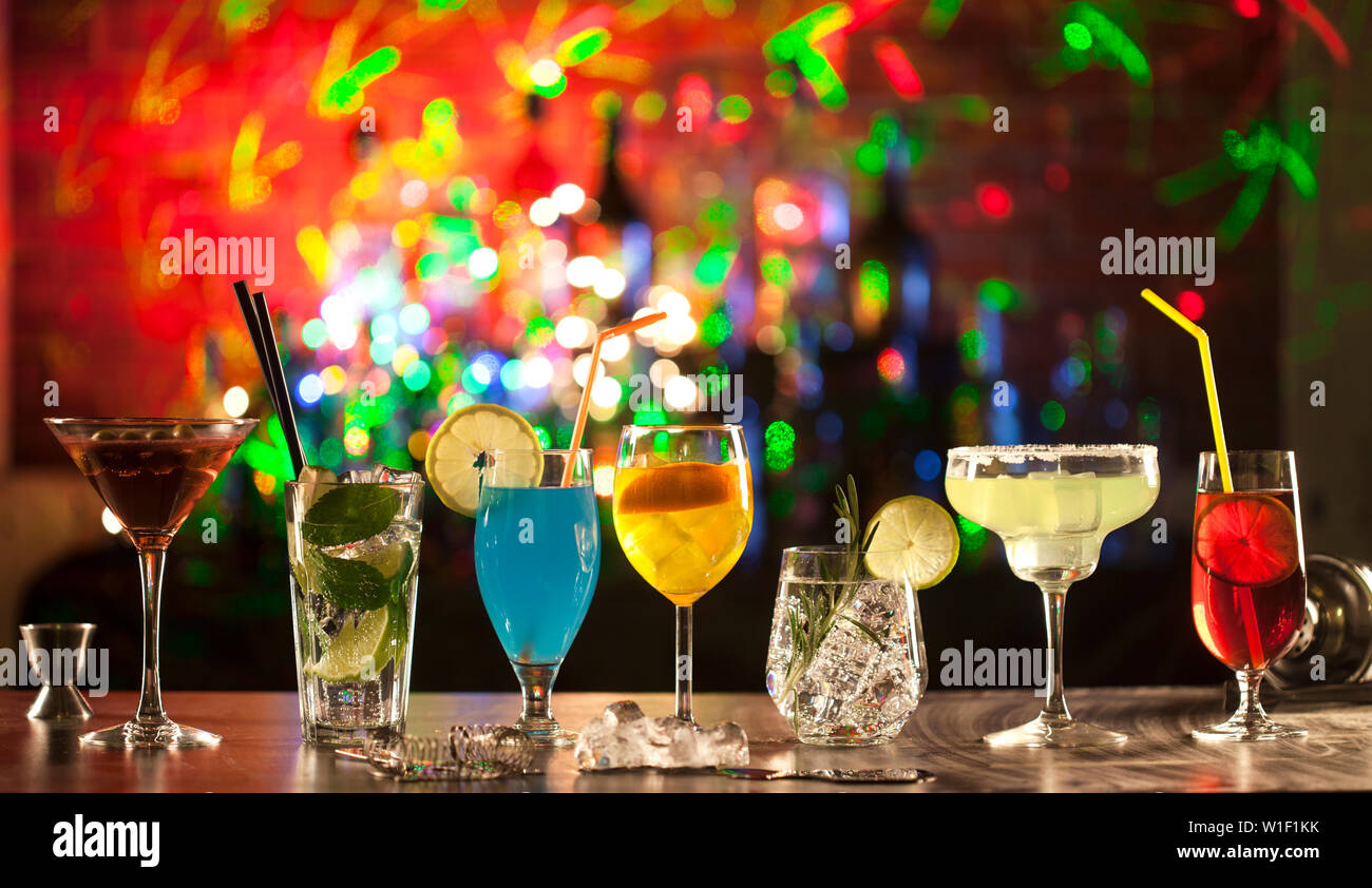 Set with different cocktails on a bar lights background Stock Photo - Alamy