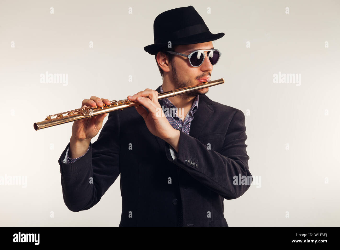 Portrait studio musician with his musical instrument Stock Photo - Alamy