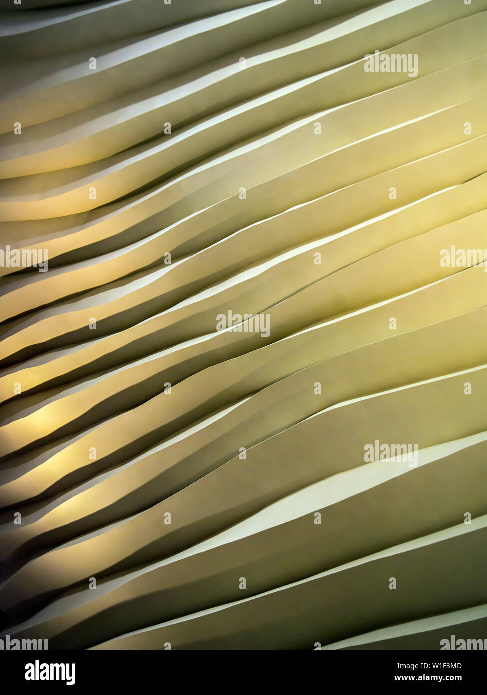 Photo of an abstract wall of uneven waves with shadows and highlights ...