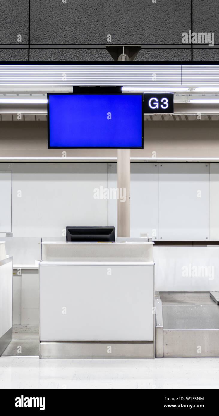 Check in counter at airport, with blue screen for copy Stock Photo - Alamy