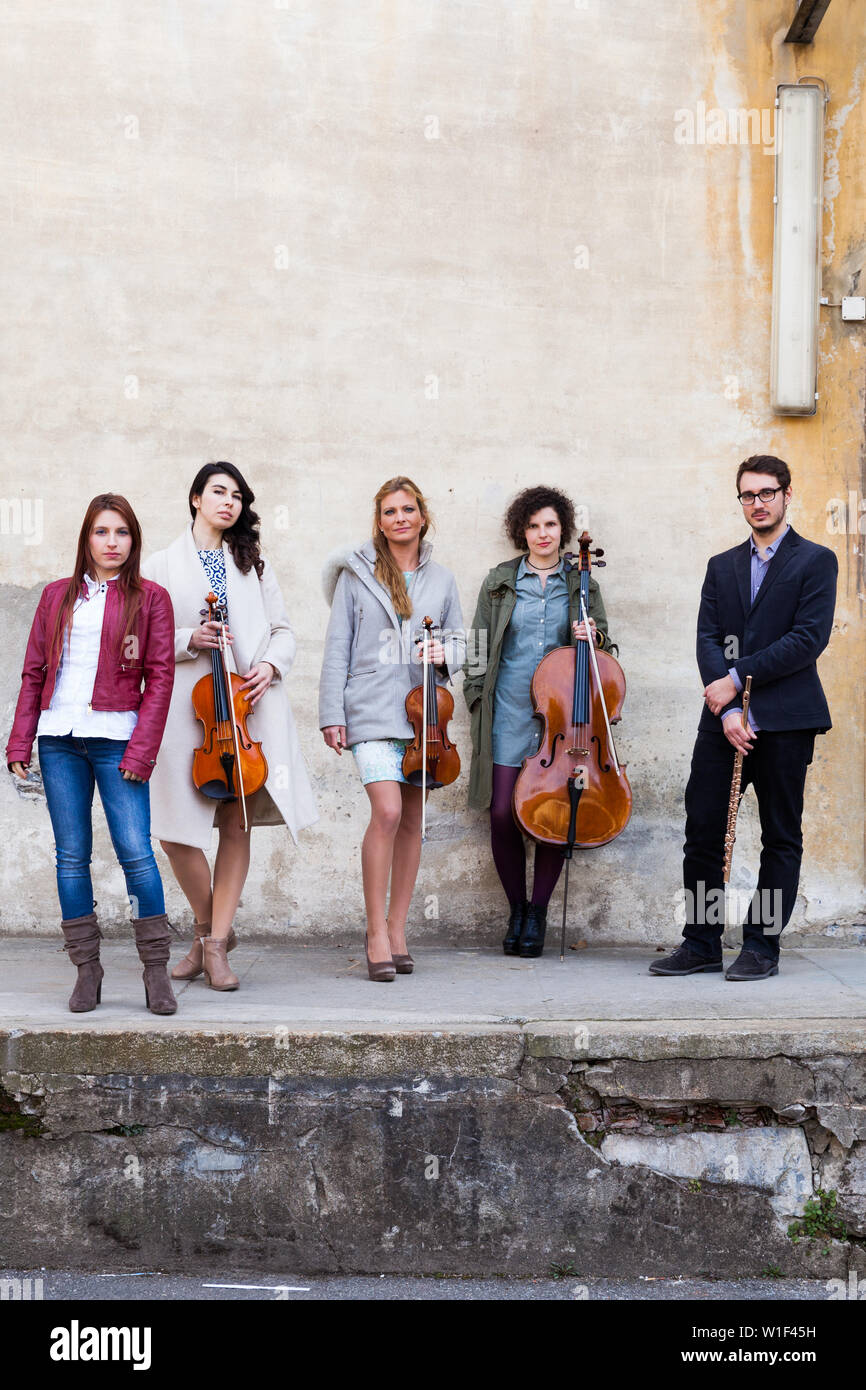 Musical band posing in front of an exterior wall Stock Photo - Alamy