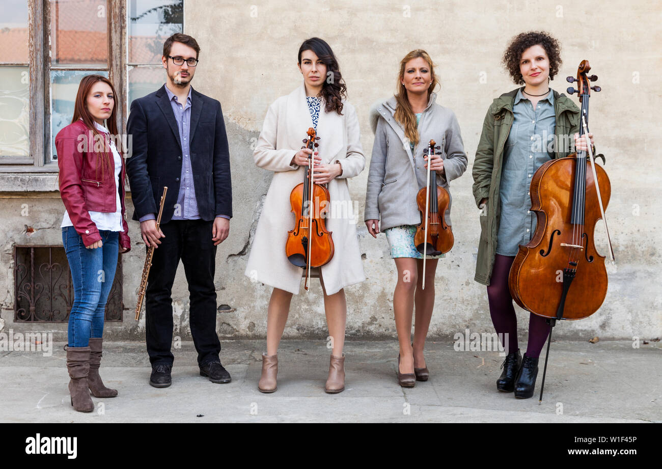 Musical band posing in front of an exterior wall Stock Photo - Alamy