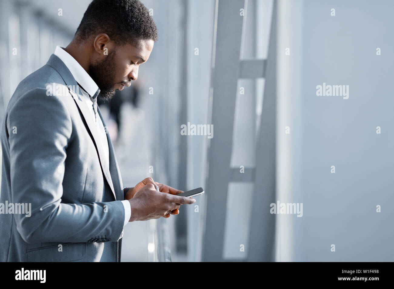 Handsome african man texting phone hi-res stock photography and images ...