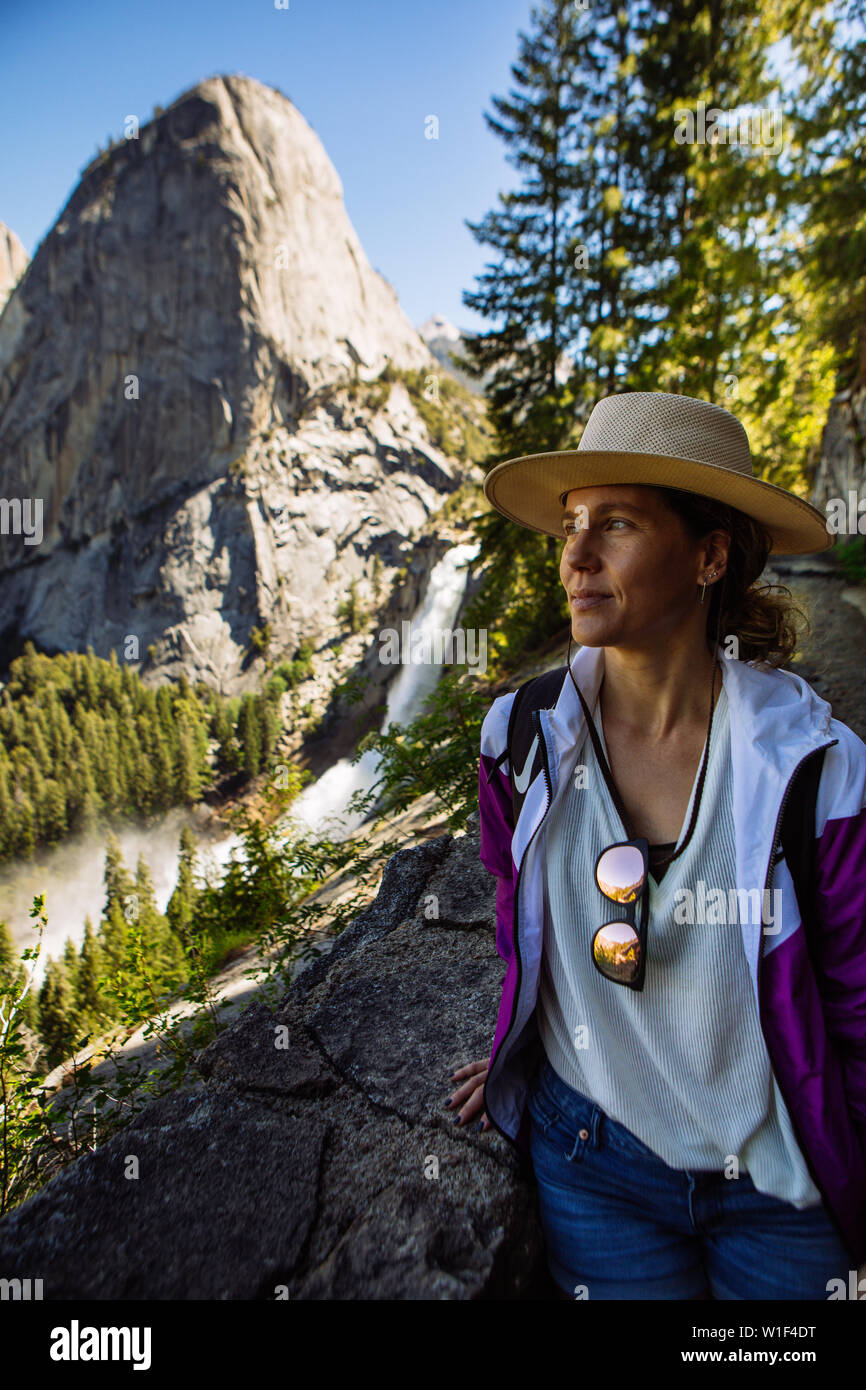 Tourist woman posing in shade John Muir Trail with Nevada Fall and ...