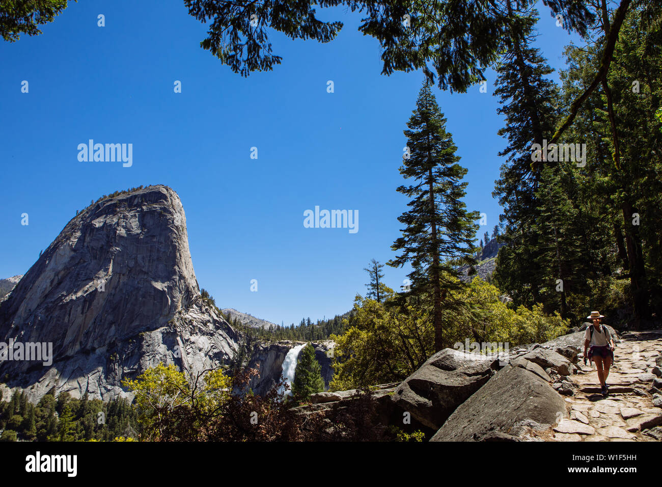 Tourist woman hiking through John Muir Trail with Nevada Fall and ...