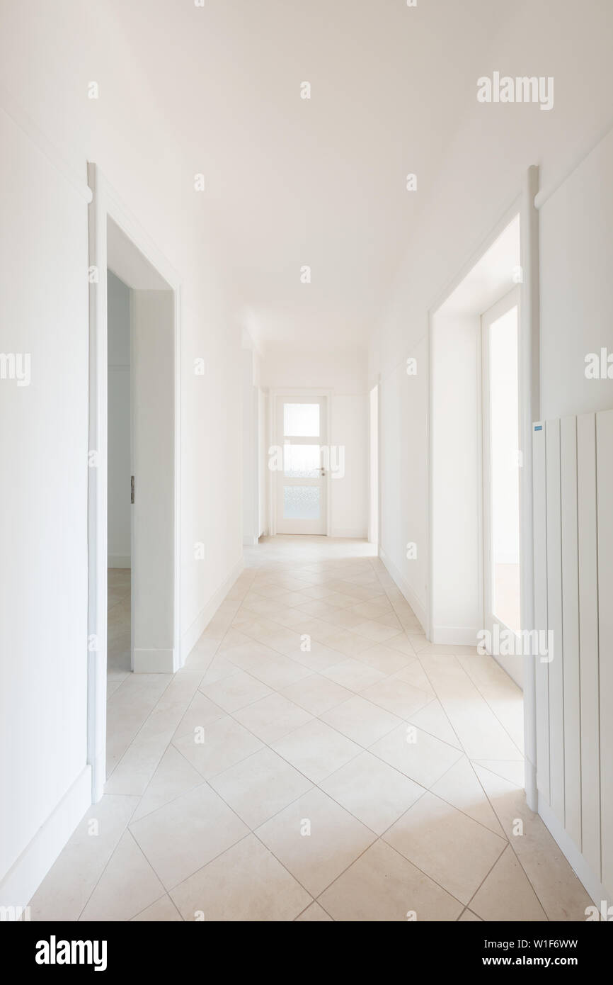 Empty corridor with three open doors Stock Photo - Alamy
