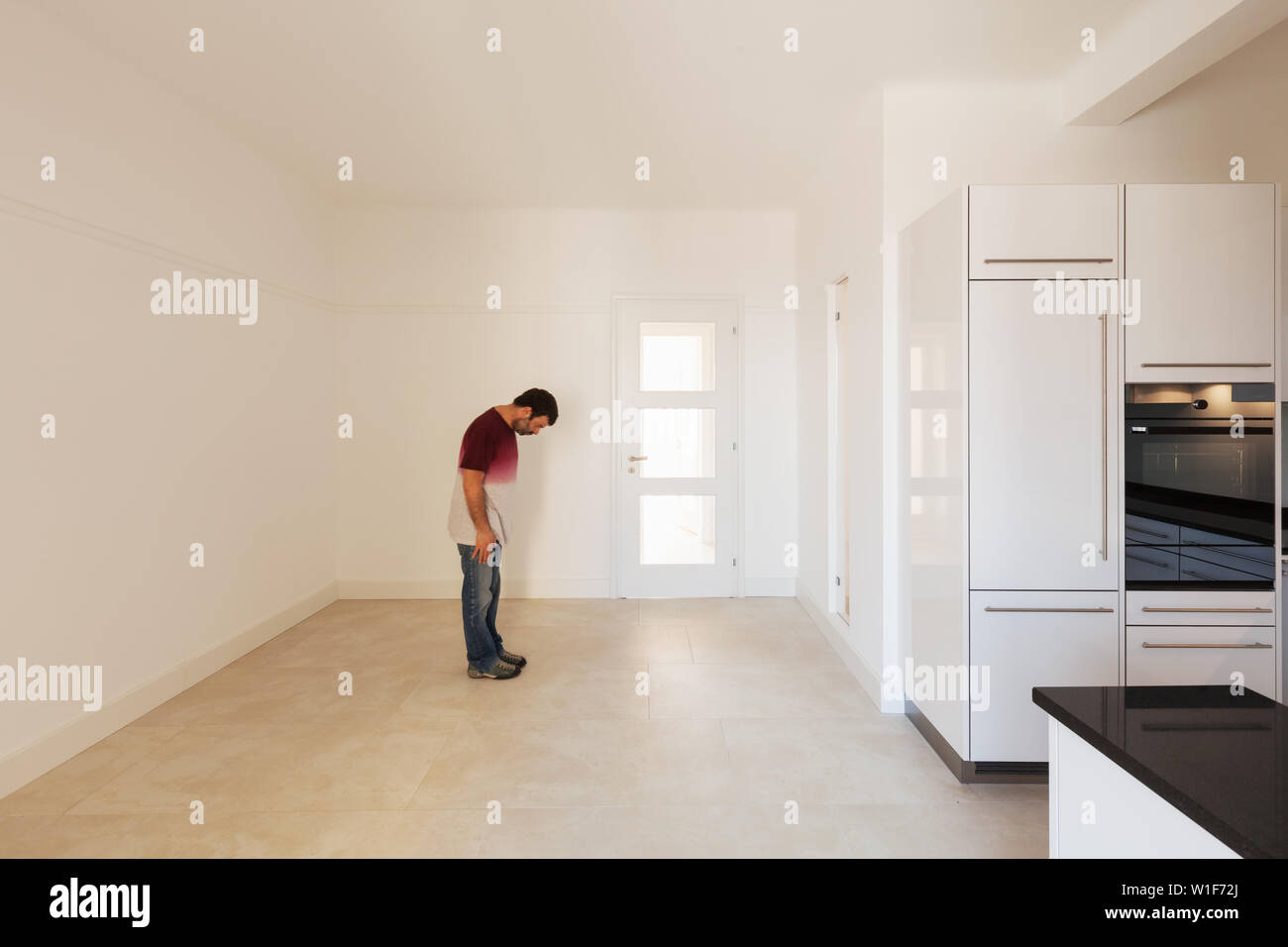 Man standing in the middle of the kitchen Stock Photo - Alamy