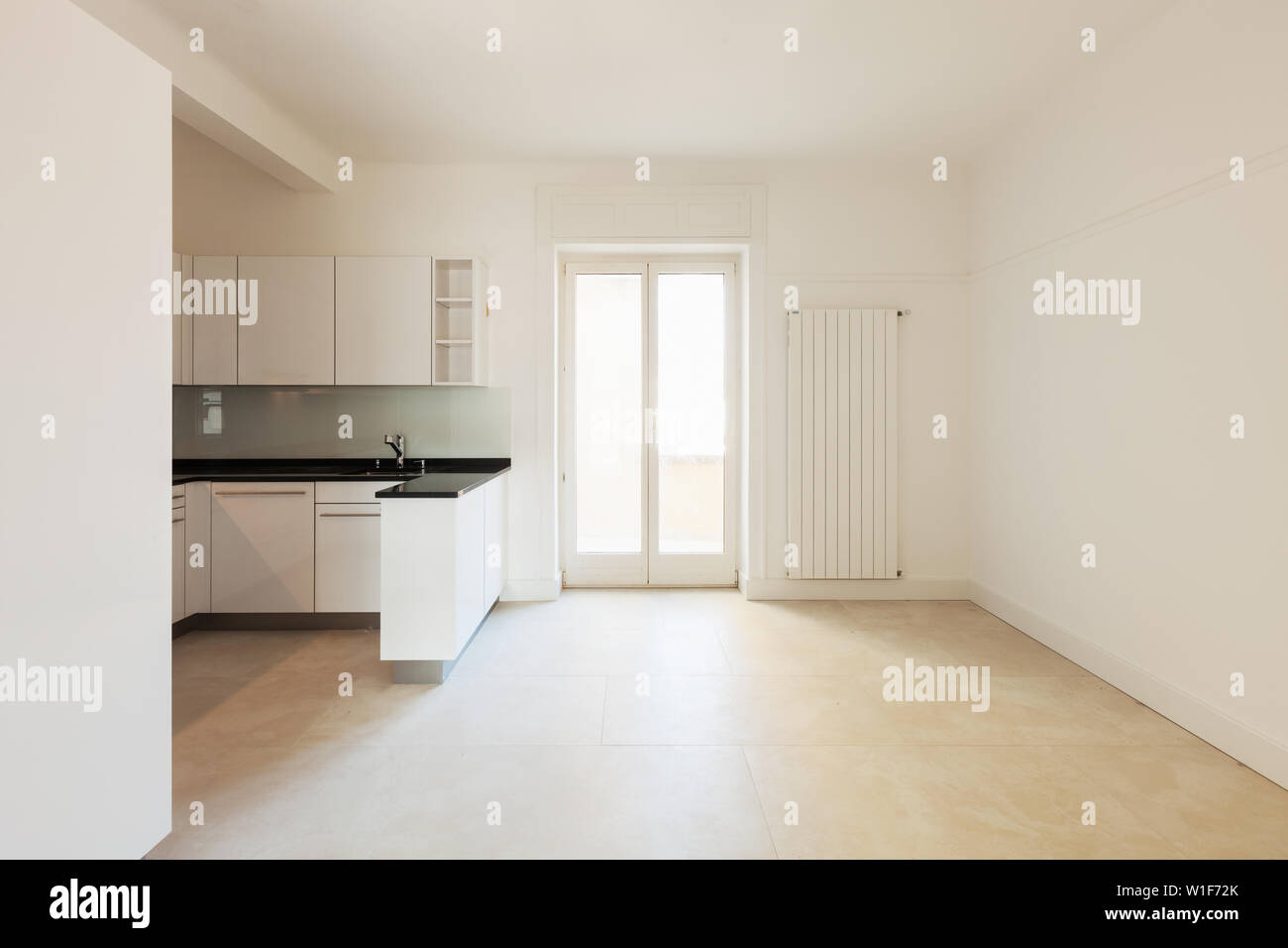 Wide white kitchen in a modern apartment Stock Photo - Alamy