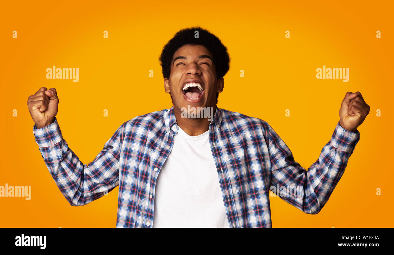Emotional Guy Screaming Yes and Raising Clenched Fists Stock Photo - Alamy
