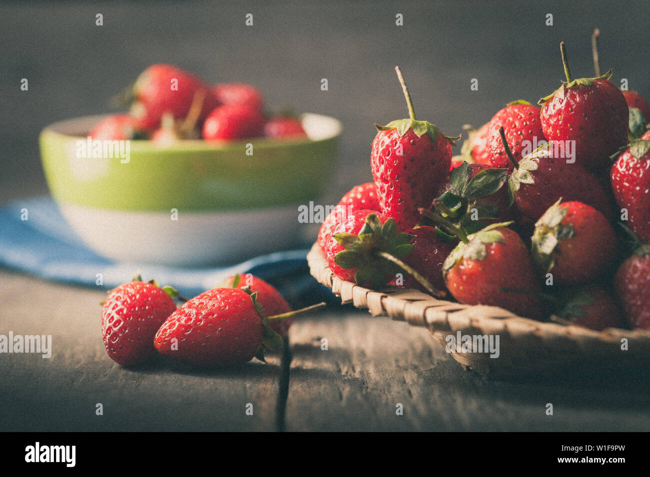 Strawberries on wood background in vintage style with film filter ...