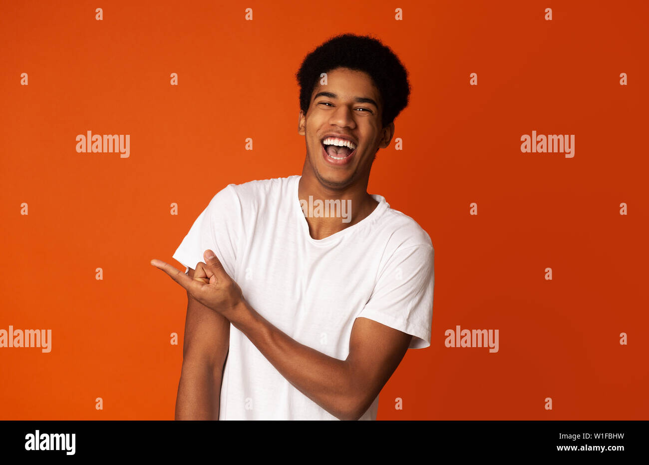 Positive Guy Pointing Fingers Away at Copy Space Stock Photo - Alamy