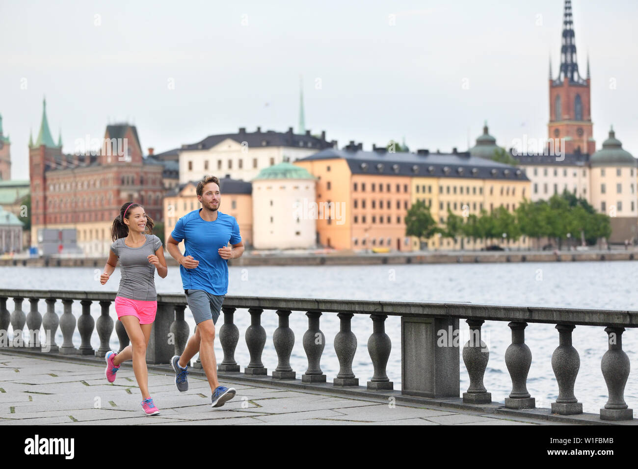 Fit fitness exercise people, healthy runners running in Stockholm city ...